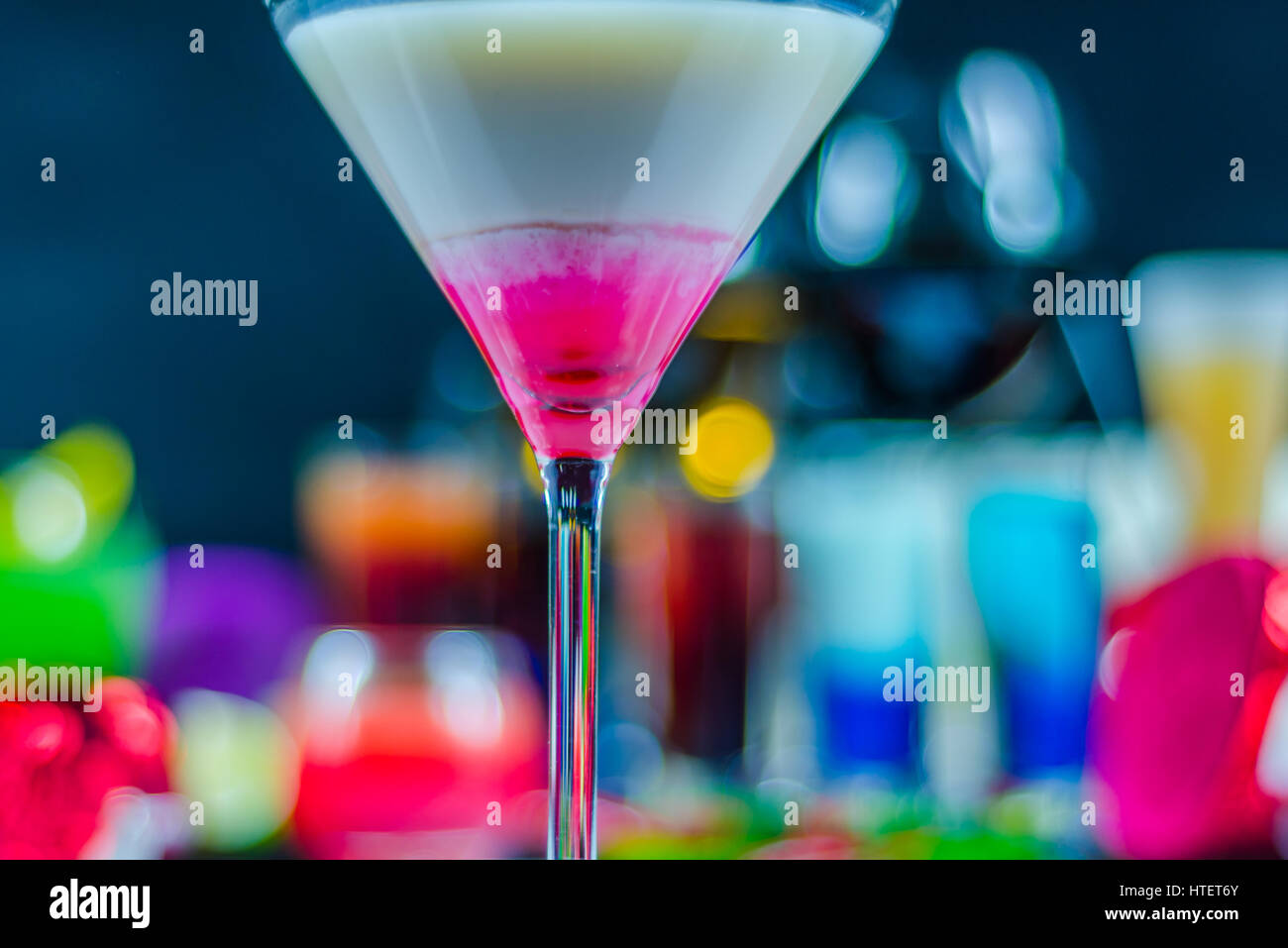 colored drink in a martini glass, a combination of white with pink ...