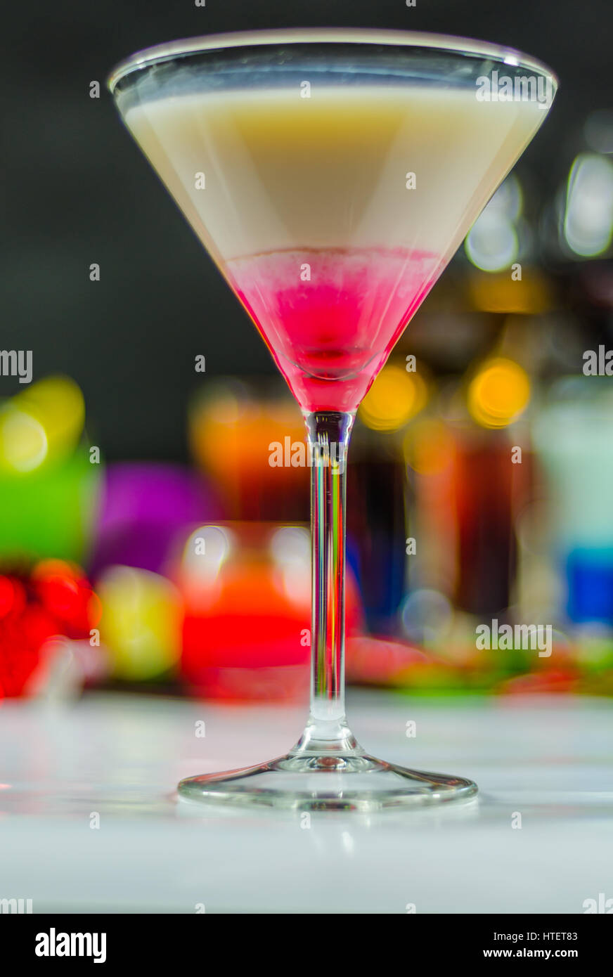 colored drink in a martini glass, a combination of white with pink ...