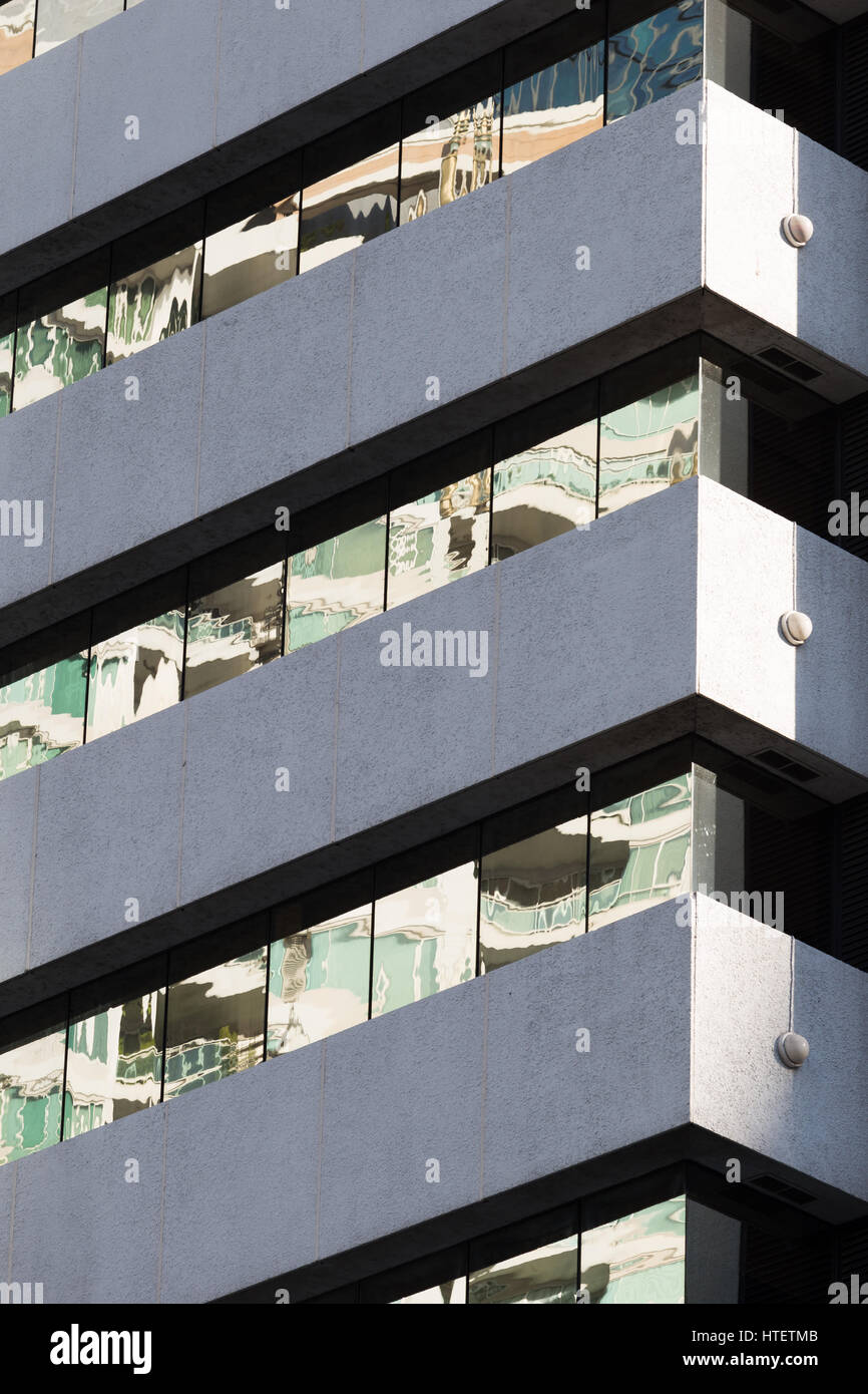 Building reflected on shiny glass wall Stock Photo - Alamy