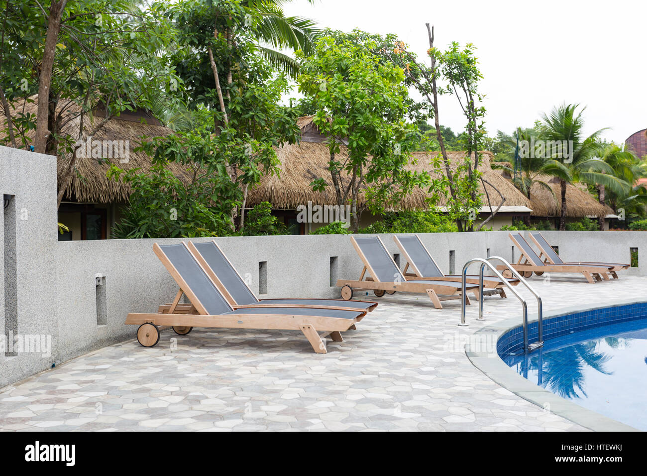 Sun loungers around the pool Stock Photo - Alamy