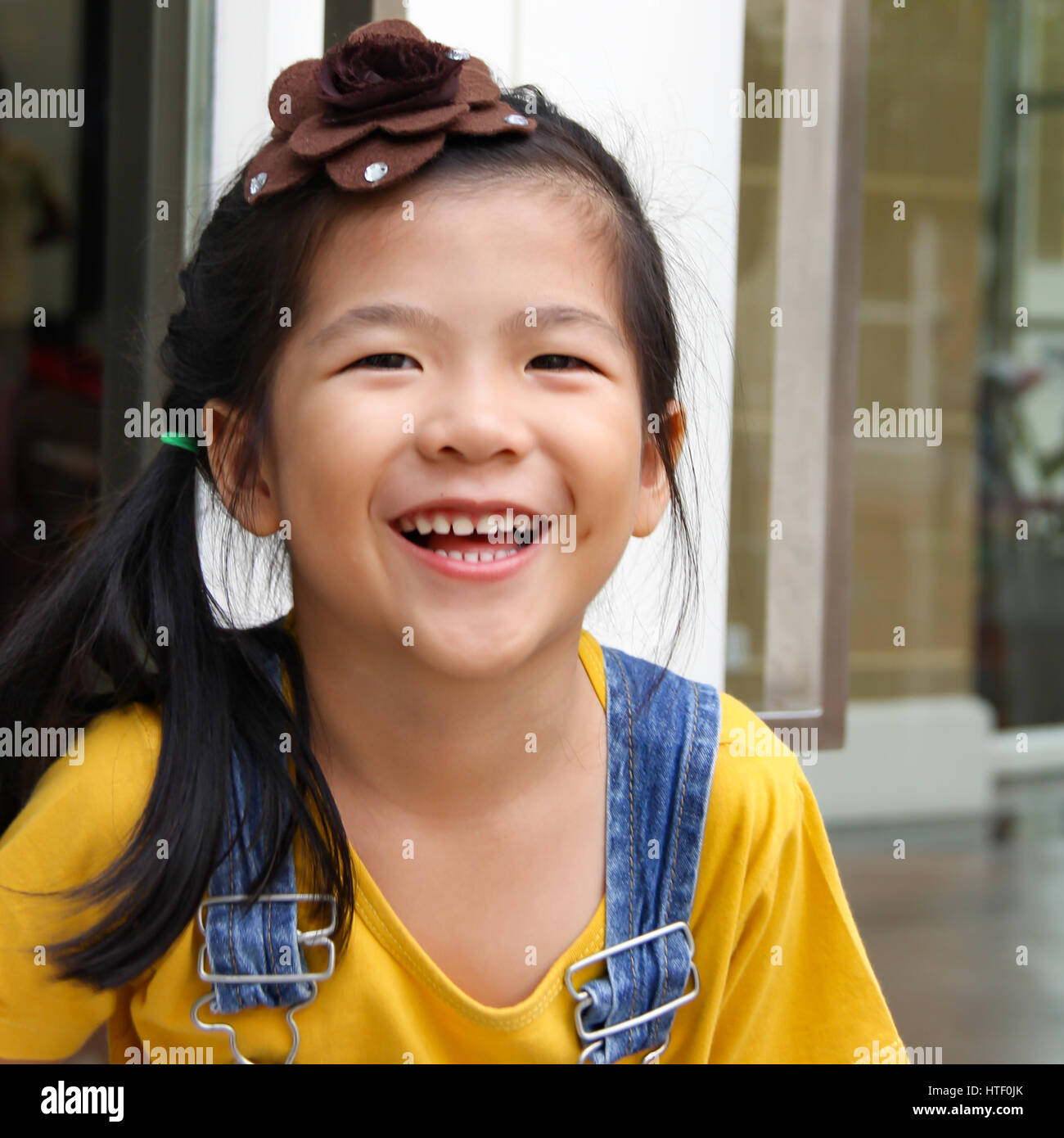 Little Asian girl in beautiful yellow dress Stock Photo - Alamy