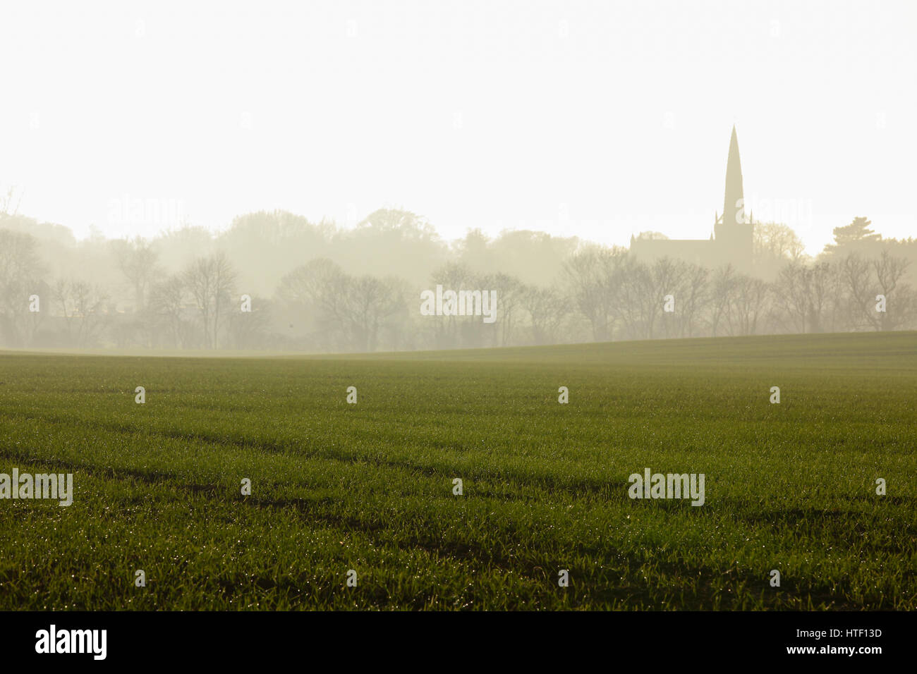 village scene sun set church looking over fields ploughed crops time ...
