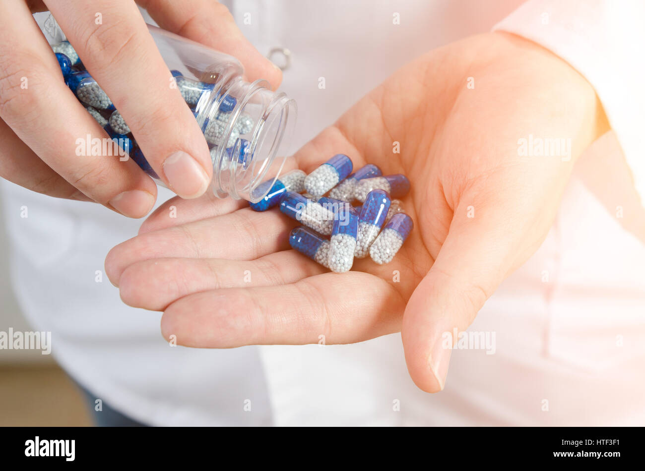 Person pouring out pills on hand. pill doctor hand pour capsule bottle ...