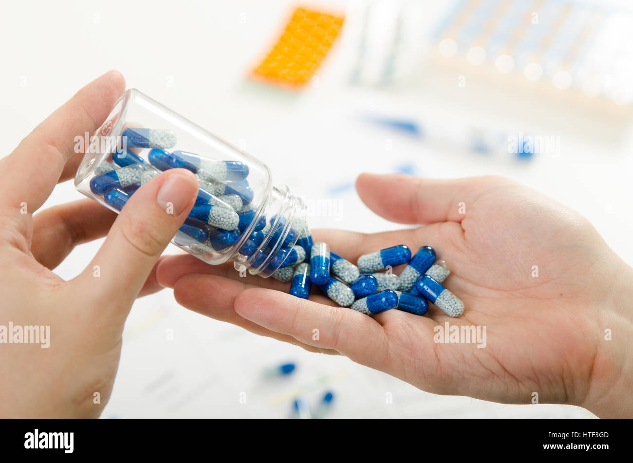 Person pouring out pills on hand. pill doctor hand pour capsule bottle ...