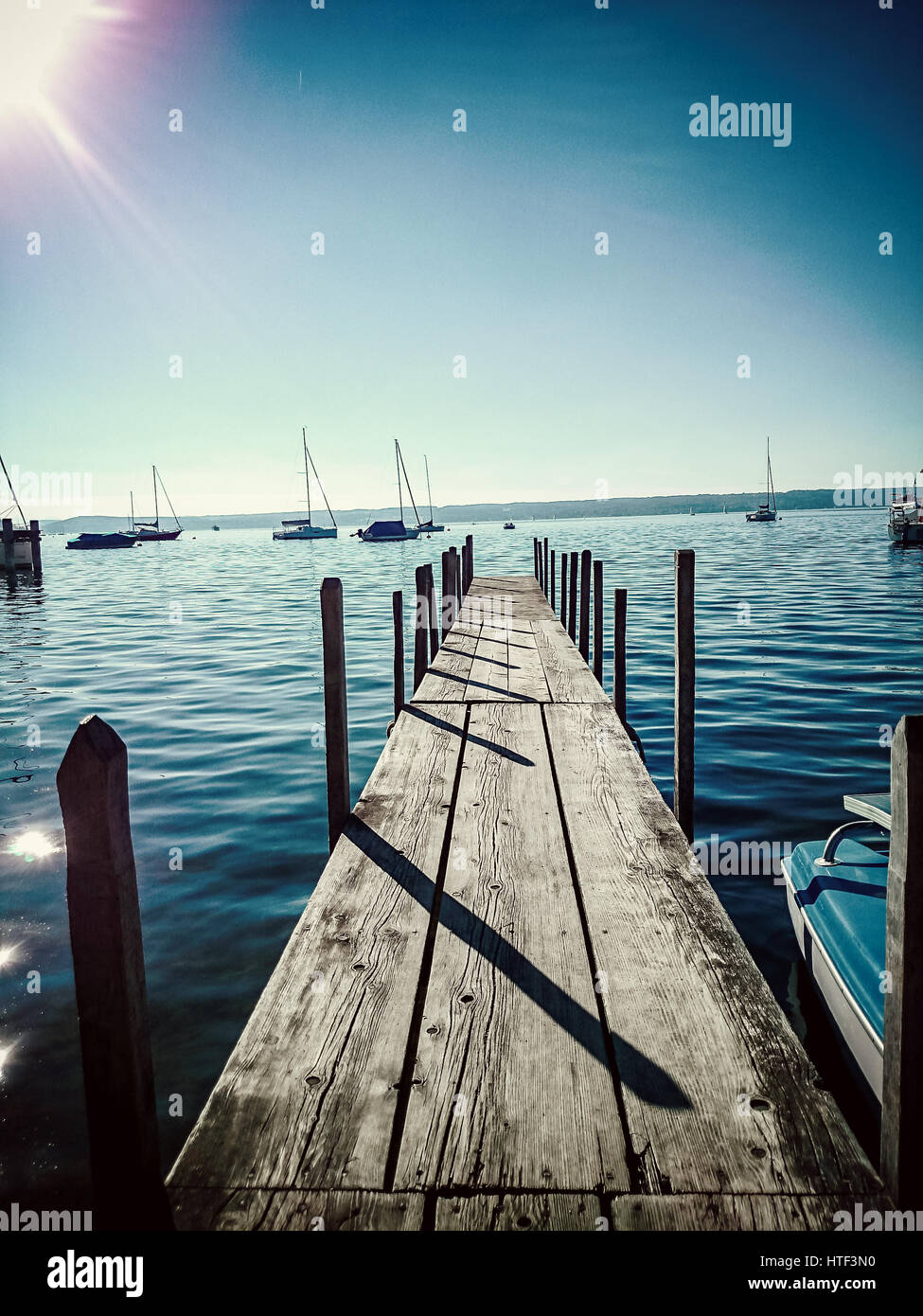 Long boat bridge at the lake with sunshine Stock Photo - Alamy