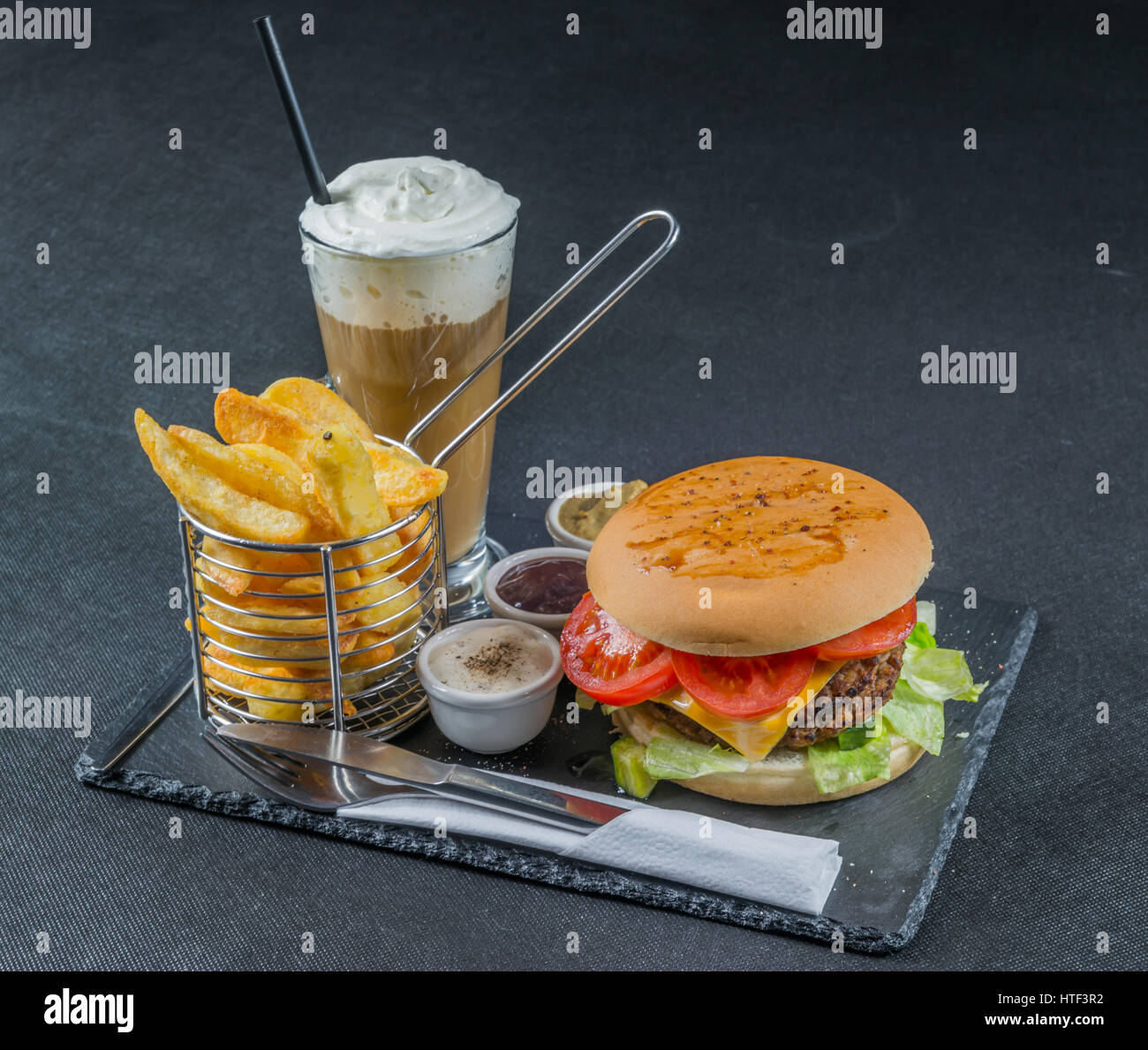 right side view on a flame grilled double stack cheeseburger, lettuce ...