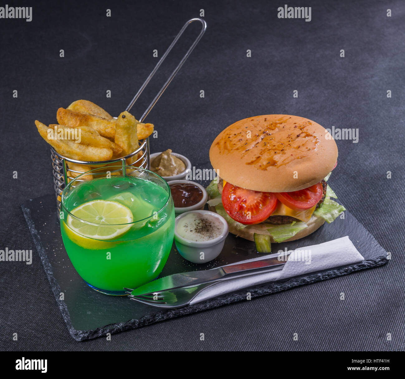 left side view on a flame grilled double stack cheeseburger, lettuce ...