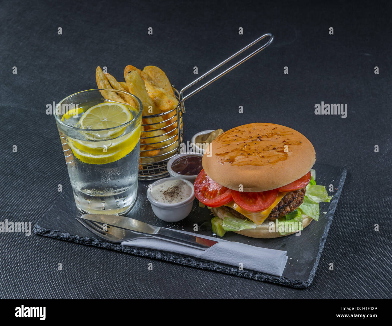 right side view on a flame grilled double stack cheeseburger, lettuce ...