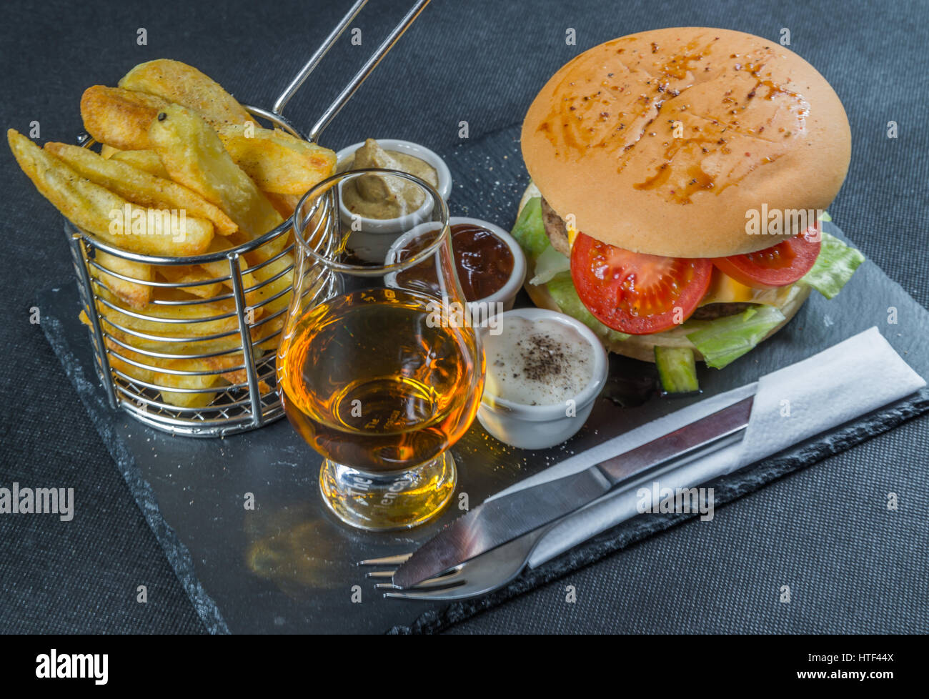 top view on a flame grilled double stack cheeseburger, lettuce, tomato ...