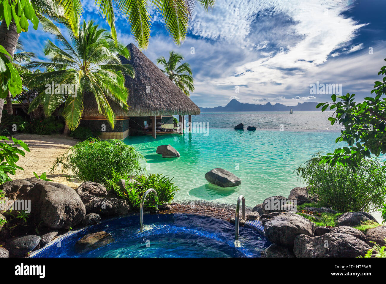 Large outdoor jacuzzi and infinity pool over tropical ocean, Tahiti ...