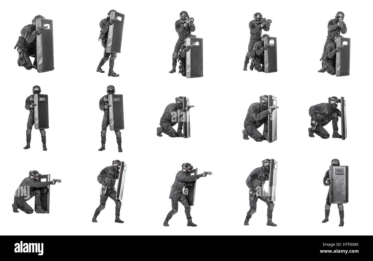Set of SWAT operators in black uniforms and bulletproof vest with ...