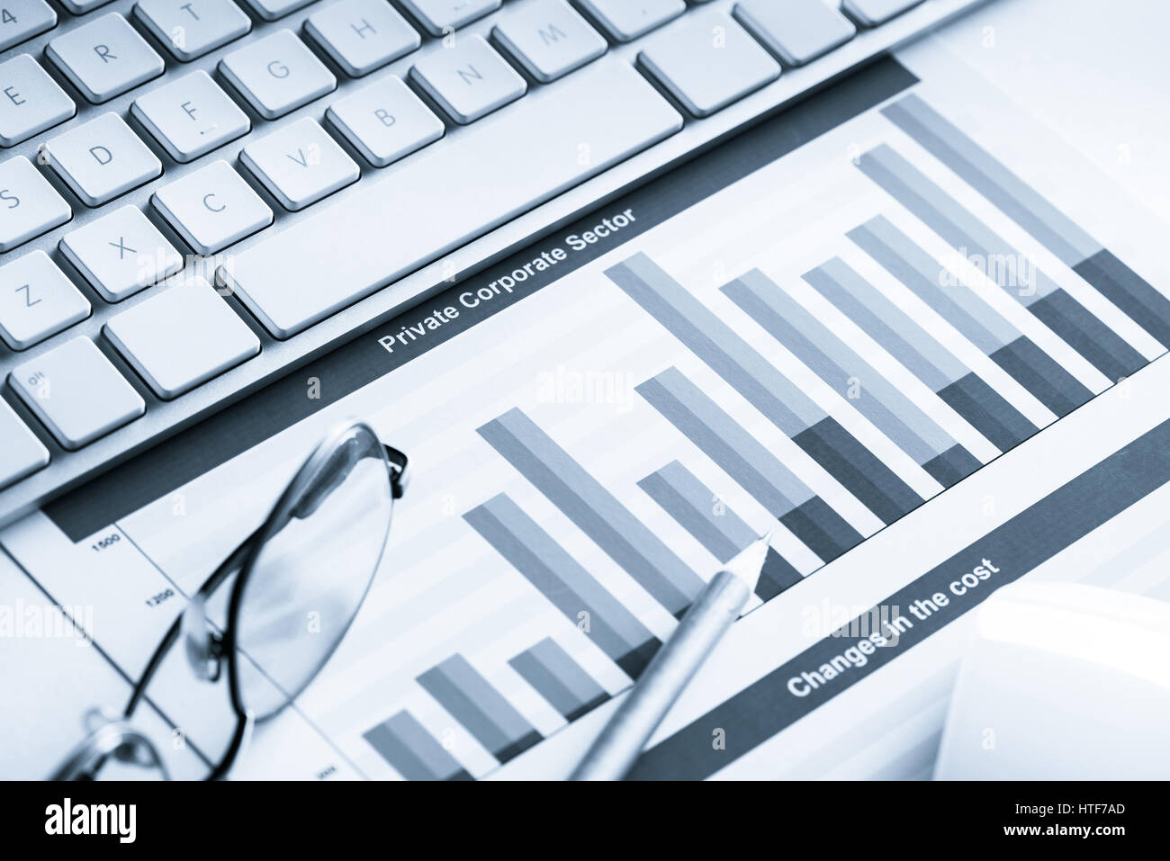 Business workplace with keyboard mouse and papers with graphs and ...