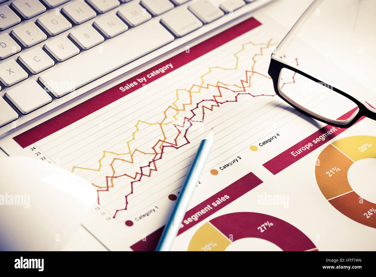 Business workplace with keyboard mouse and papers with graphs and ...