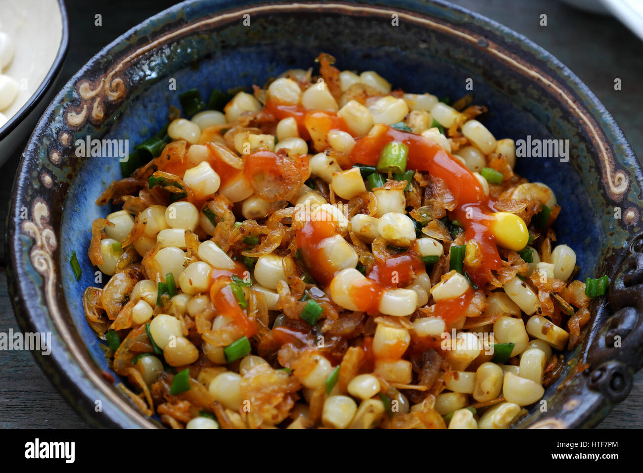 Vietnamese street food, corn fried dried shrimp, is popular snack food ...