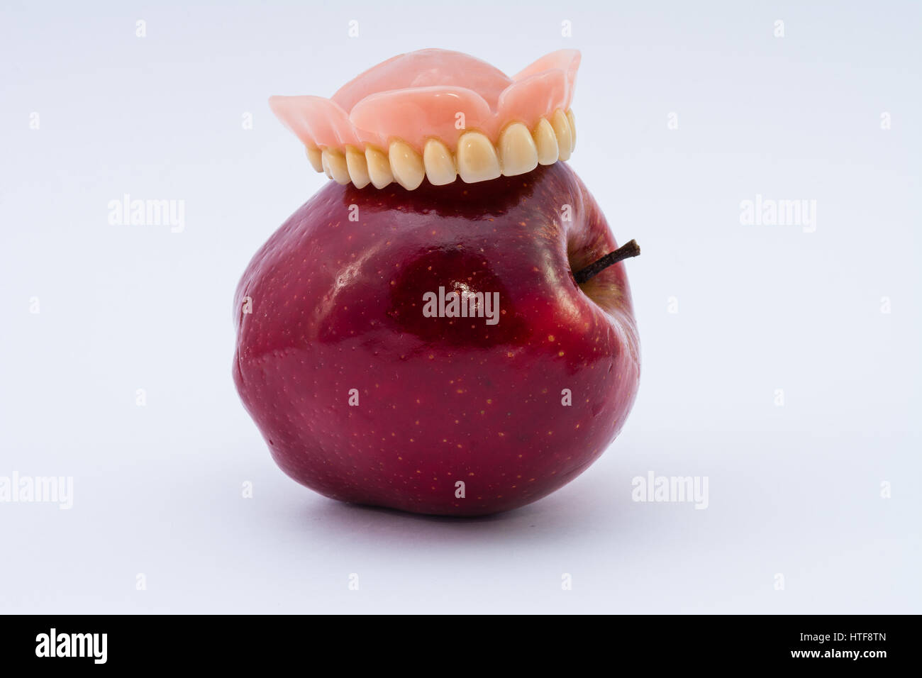 Apple and dental prosthesis Stock Photo - Alamy