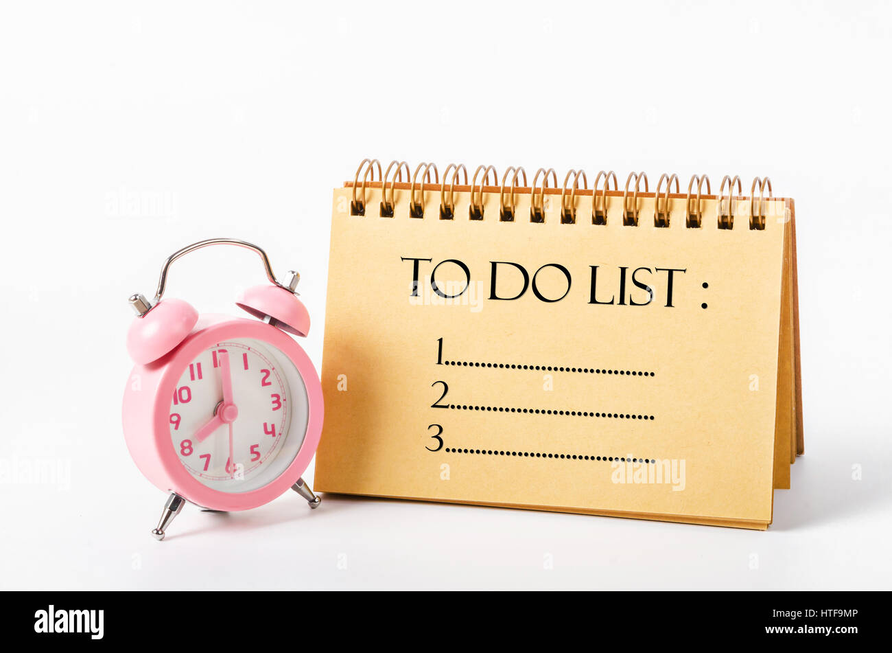 To do list and alarm clock on white background Stock Photo - Alamy