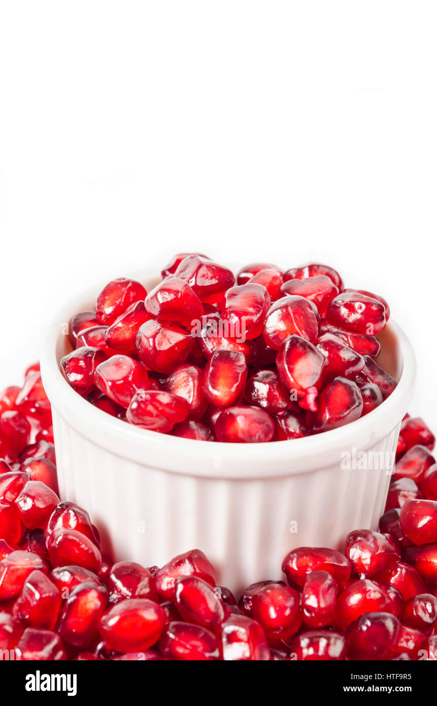Fresh pomegranate in cup on white background Stock Photo - Alamy