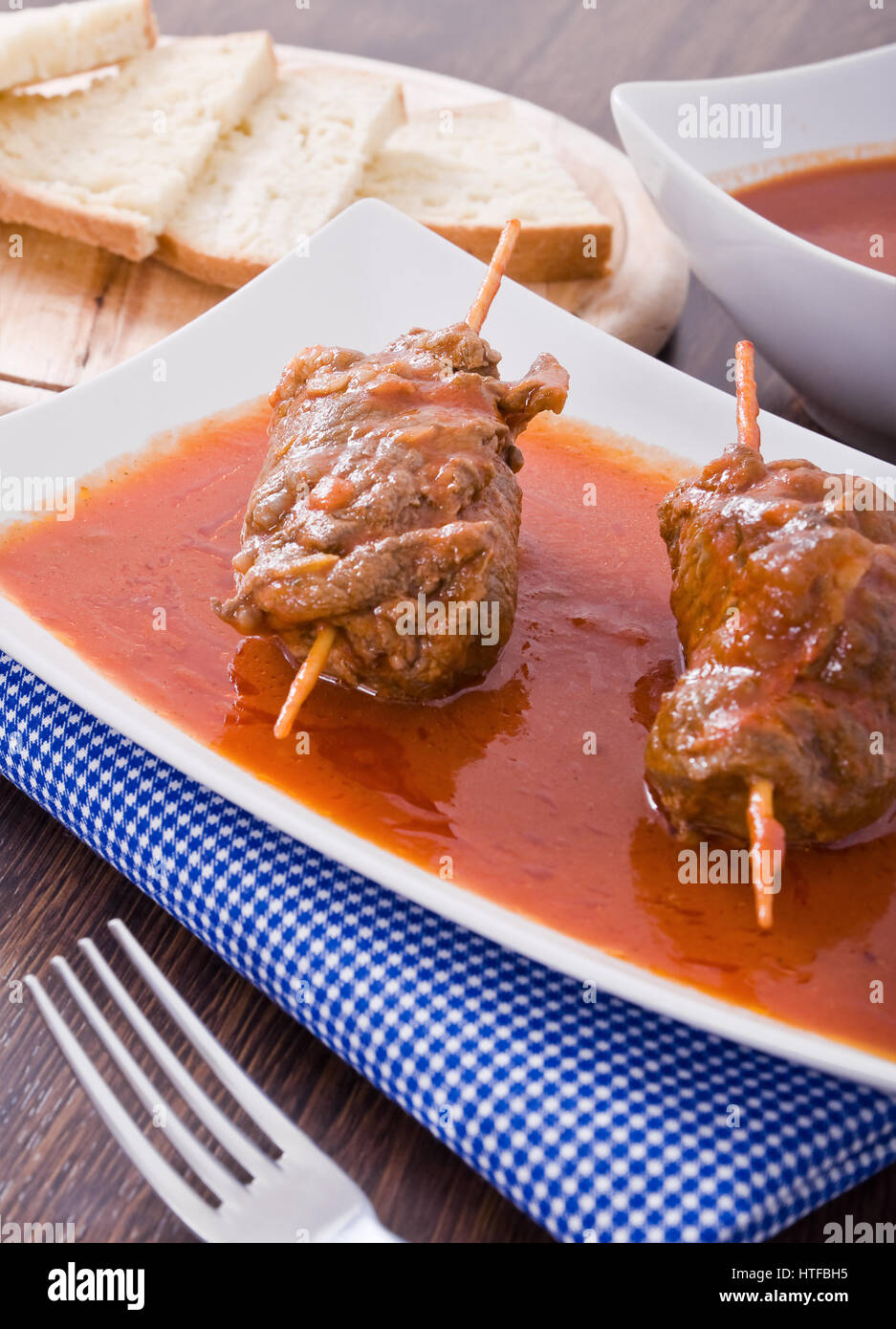 Meat roulade on white dish Stock Photo - Alamy