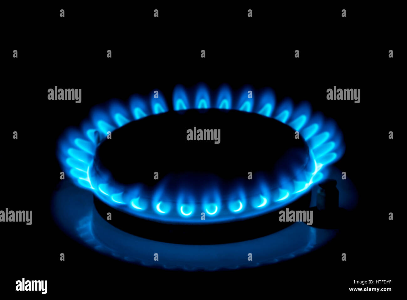 Natural gas burning a blue flames on black background Stock Photo - Alamy