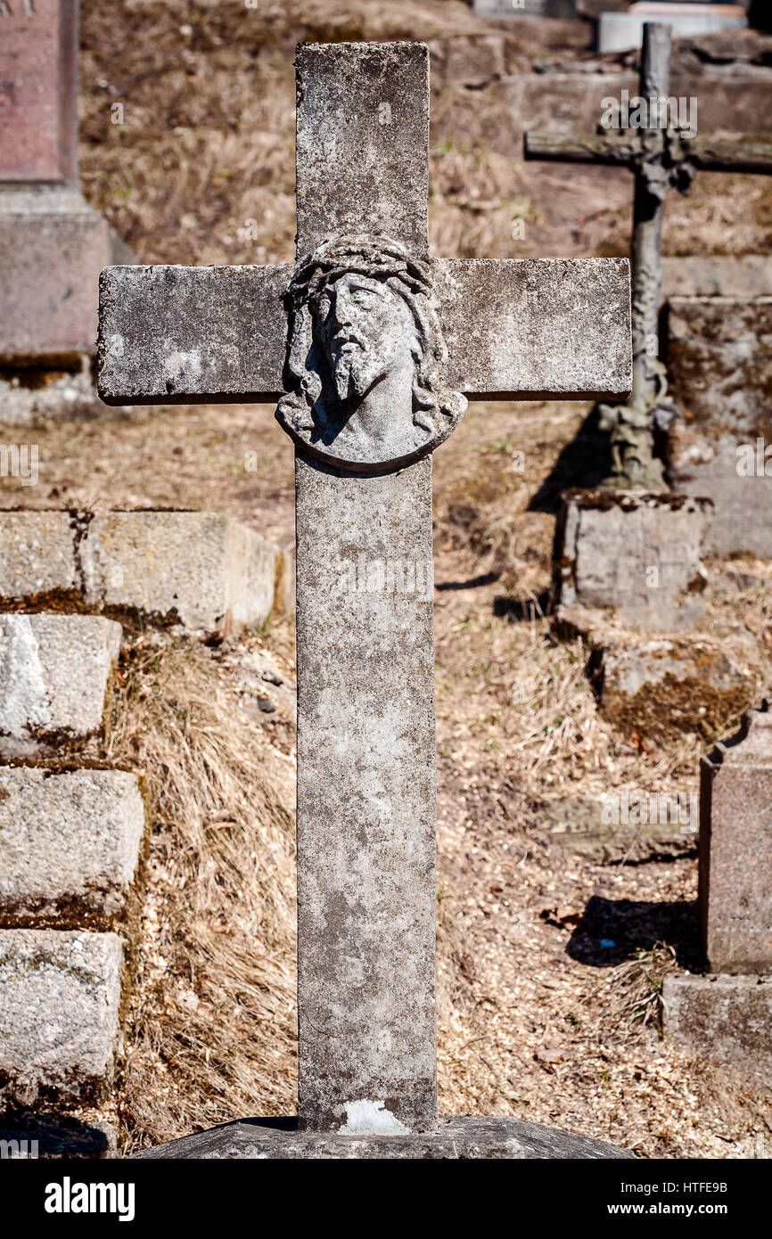 Old concrete cross with face of Jesus Christ in Rasu cemetery ...