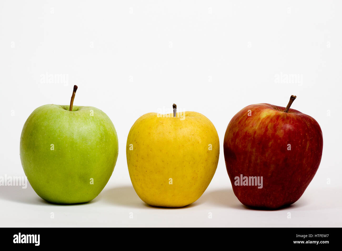 Three colorful apples with a white background Stock Photo - Alamy