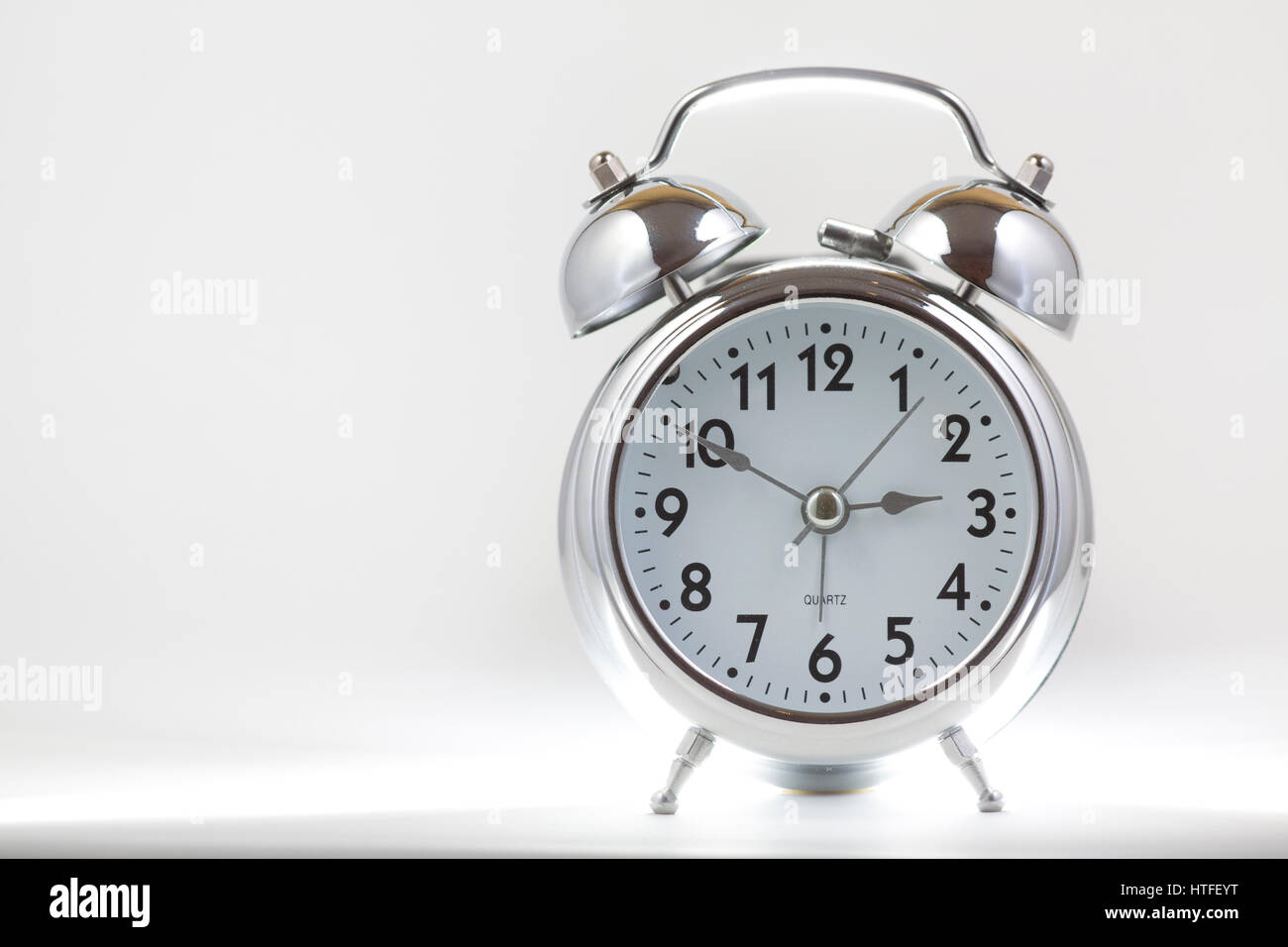 Clock on white background Stock Photo - Alamy