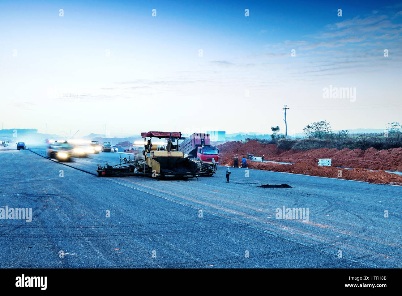 Workers on a road construction, industry and teamwork Stock Photo - Alamy