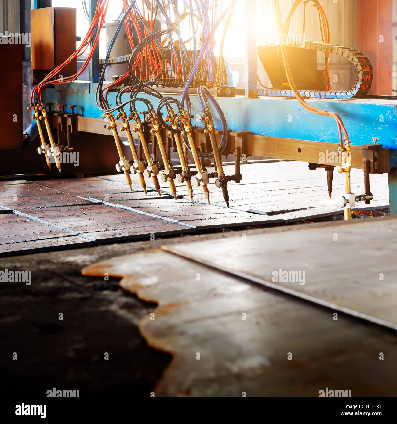 Steel factory production lines: flame cutting machine Stock Photo - Alamy