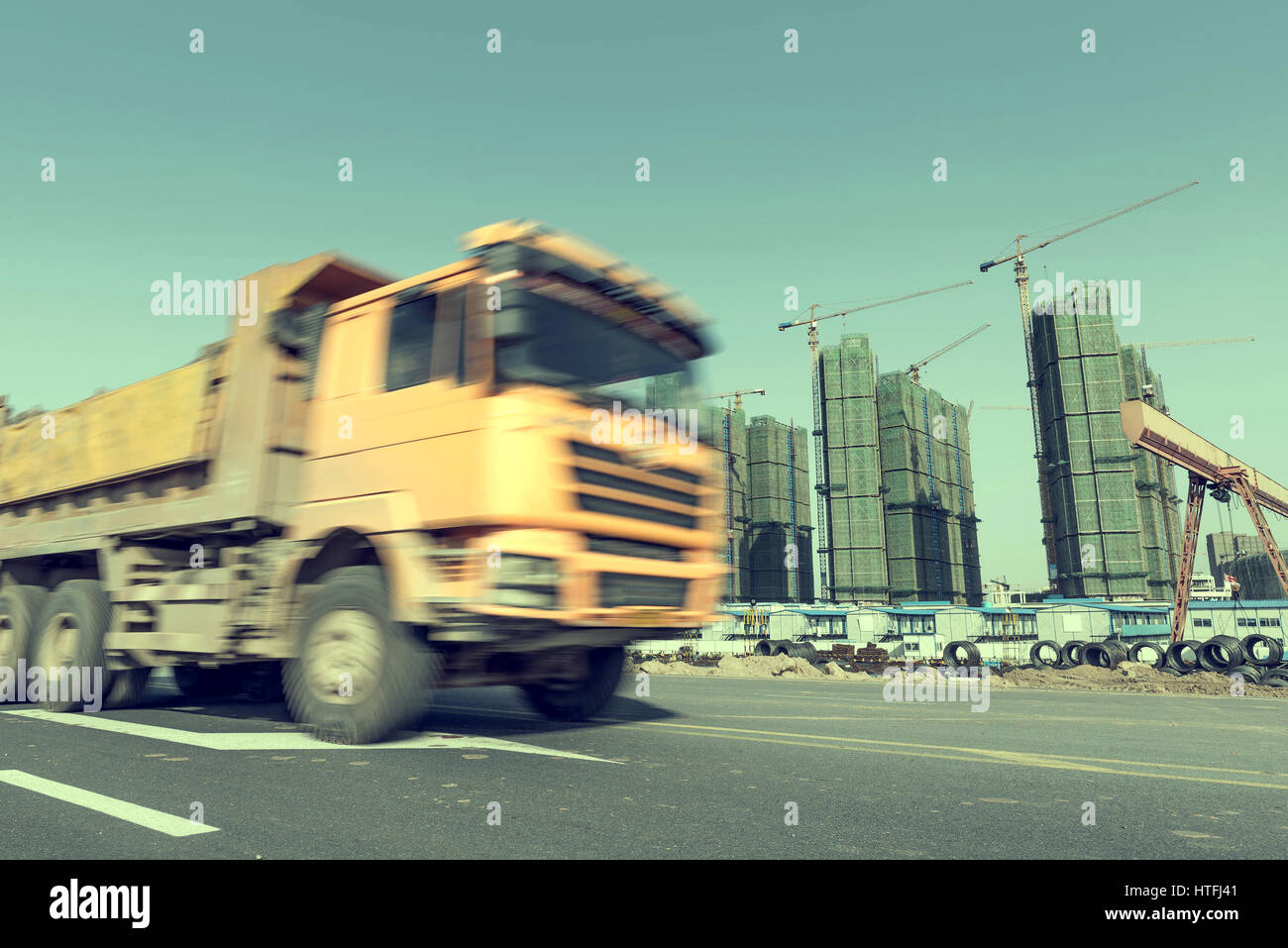 Busy construction site, a large truck speed by Stock Photo - Alamy