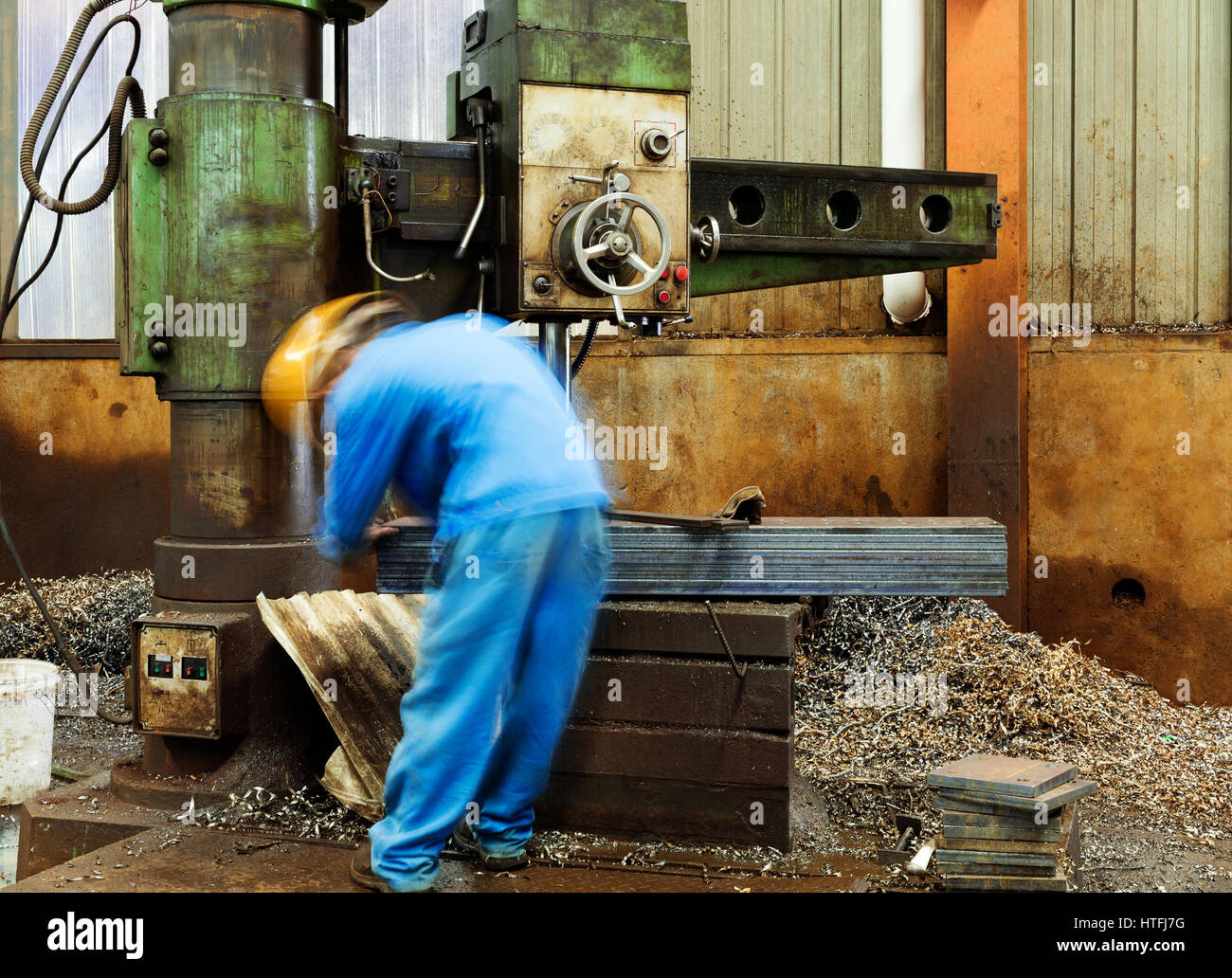 Engineer Using Drill In Factory Stock Photo - Alamy