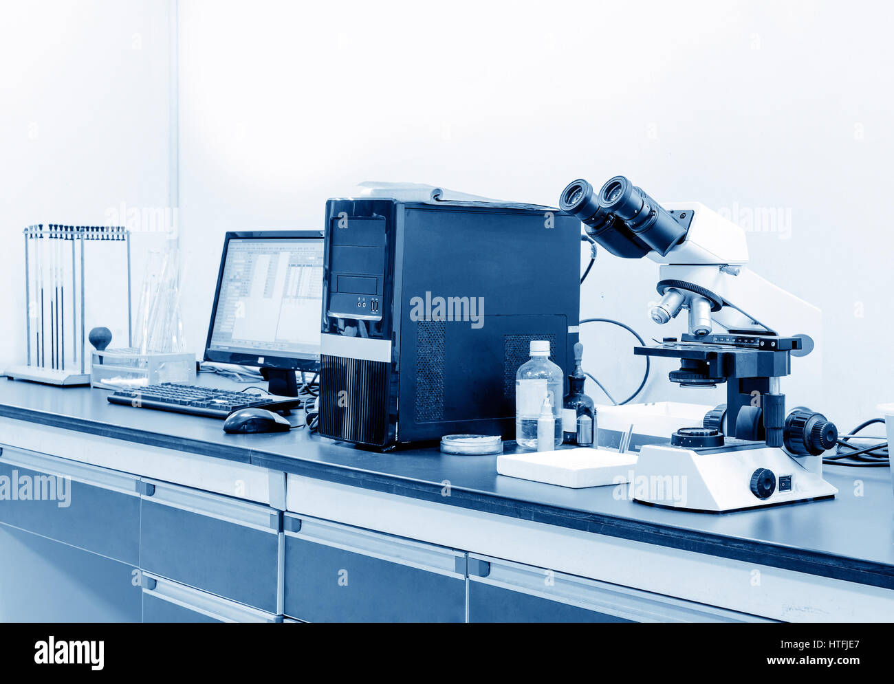 Microscope isolated against white background Stock Photo - Alamy