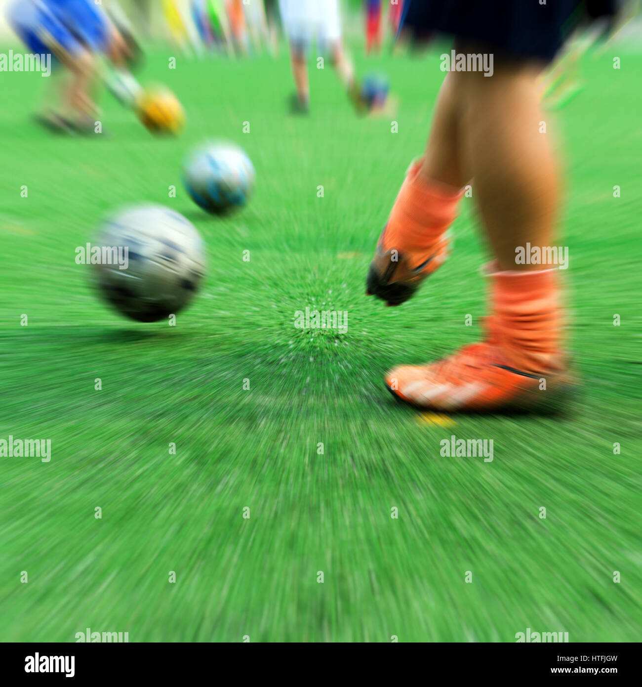 Close-up of little boy playing football on football pitch Stock Photo ...