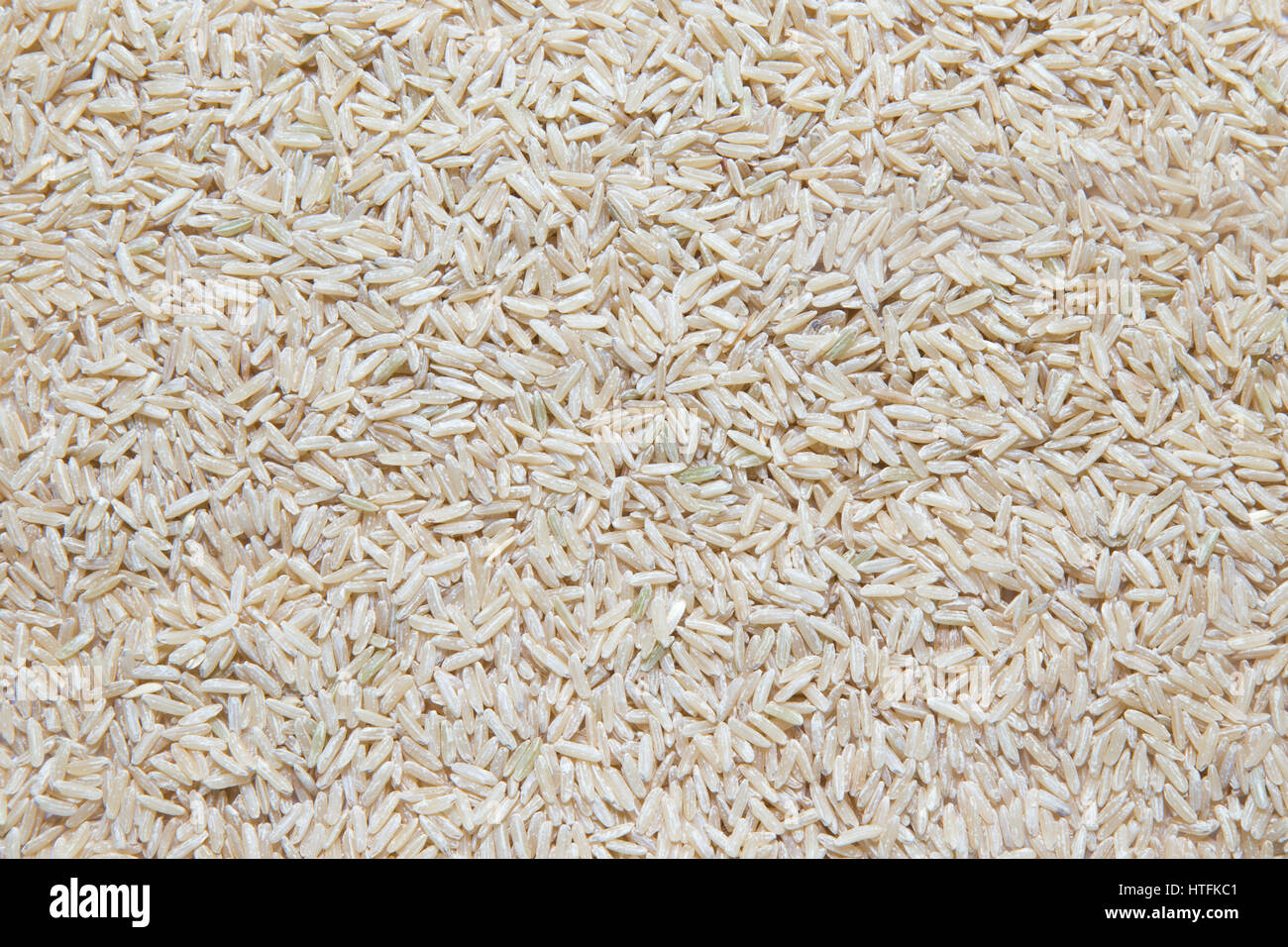 Uncooked Brown rice closeup , background Stock Photo - Alamy