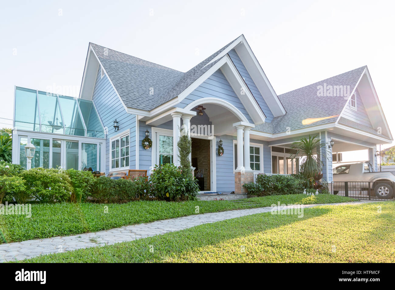 Bright blue house in sunlght with colorful poppies and some graceful ...