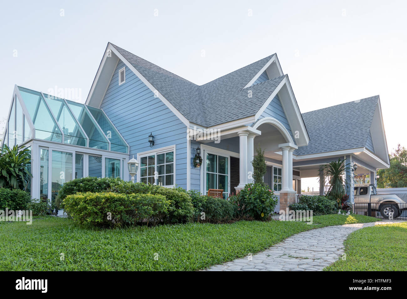 Bright blue house in sunlght with colorful poppies and some graceful ...