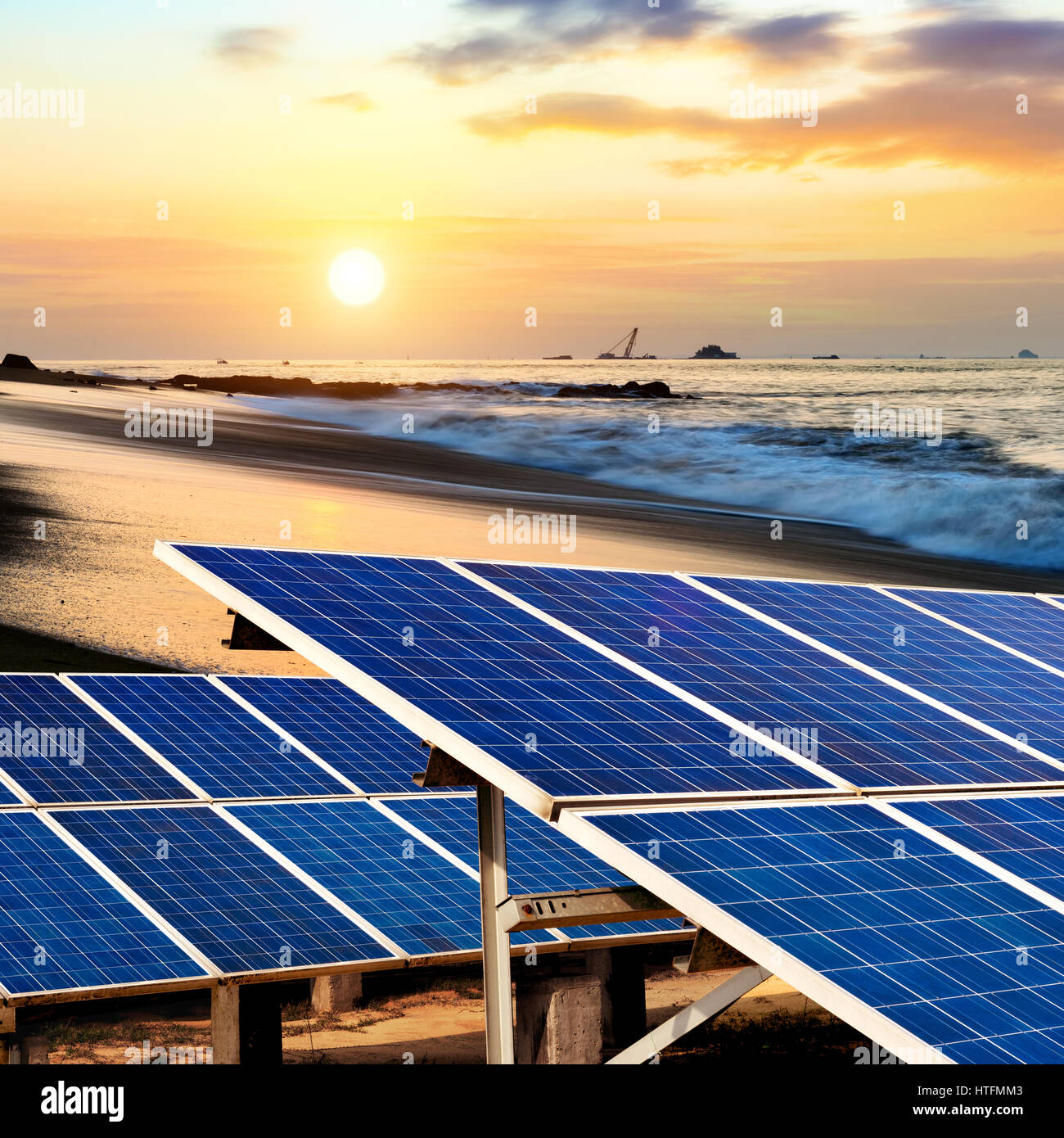 A secluded beach, there are a lot of rocks and solar panels Stock Photo ...