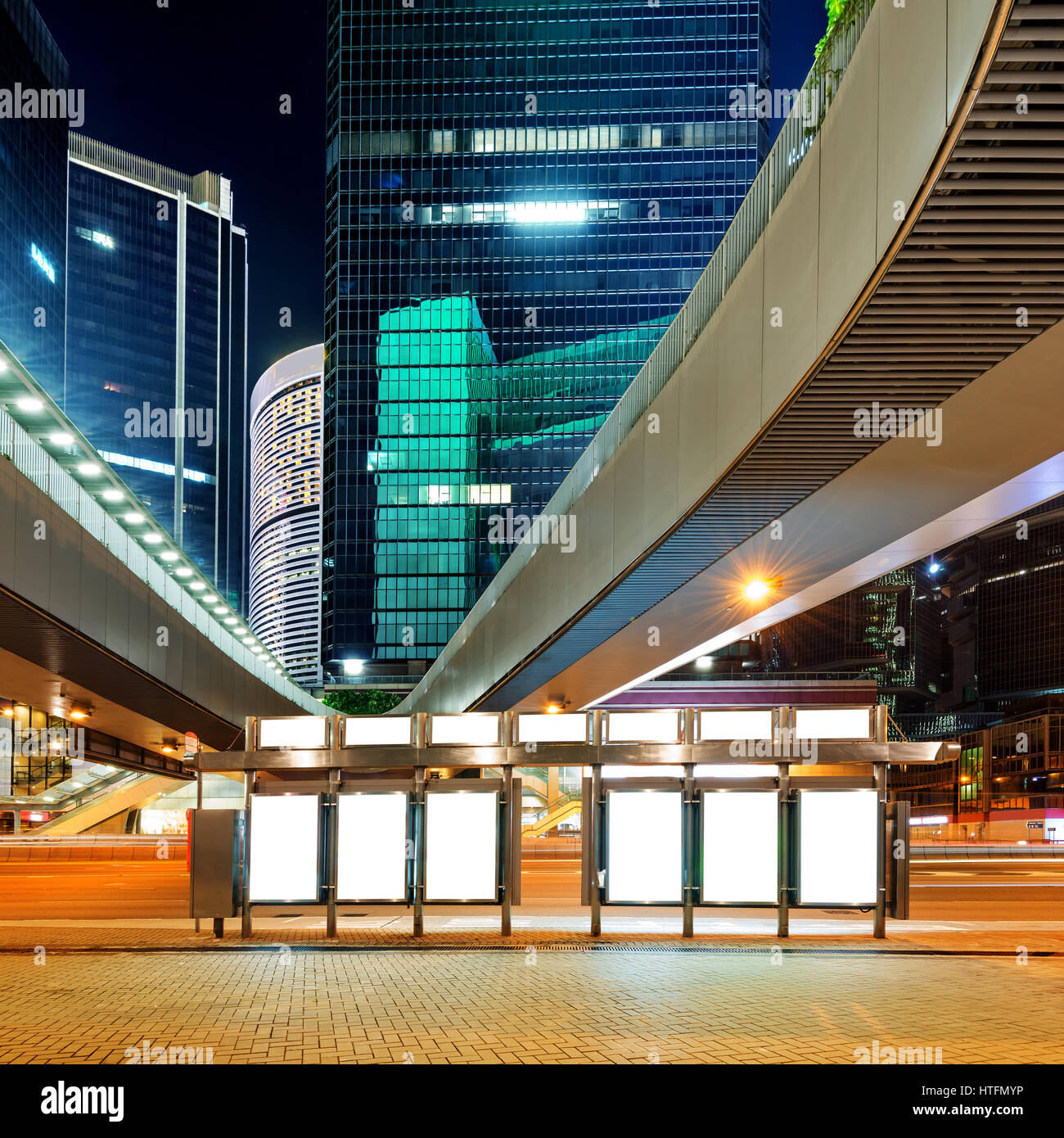 Road car light trails through at modern city advertising light boxes ...