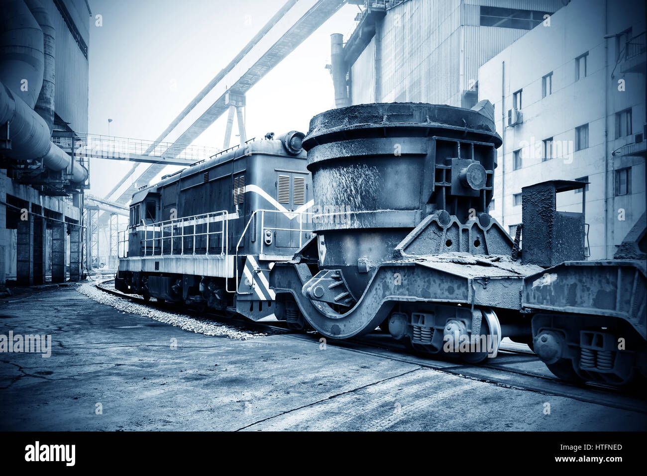 Steelworks landscape, train loaded with huge cans Stock Photo - Alamy
