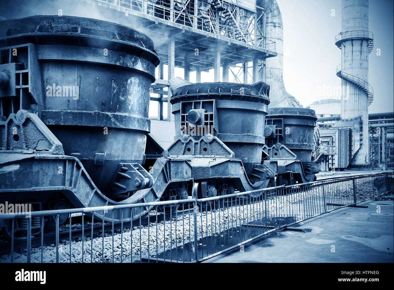 Steelworks landscape, train loaded with huge cans Stock Photo - Alamy