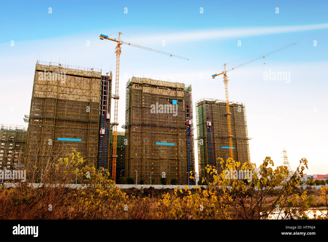 Big Construction Site with Working Cranes at dusk for Business Stock ...