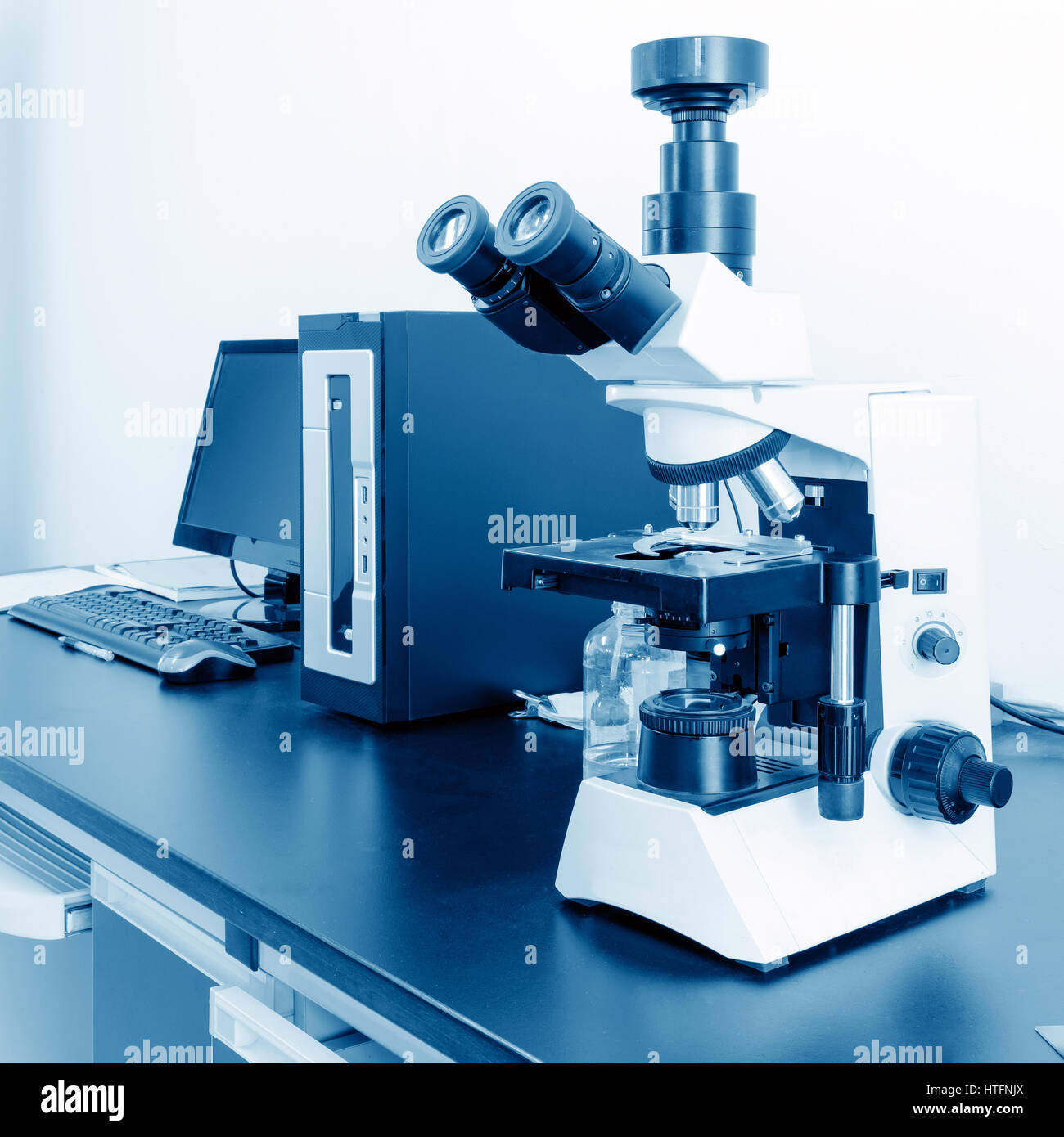 Microscope isolated against white background Stock Photo - Alamy