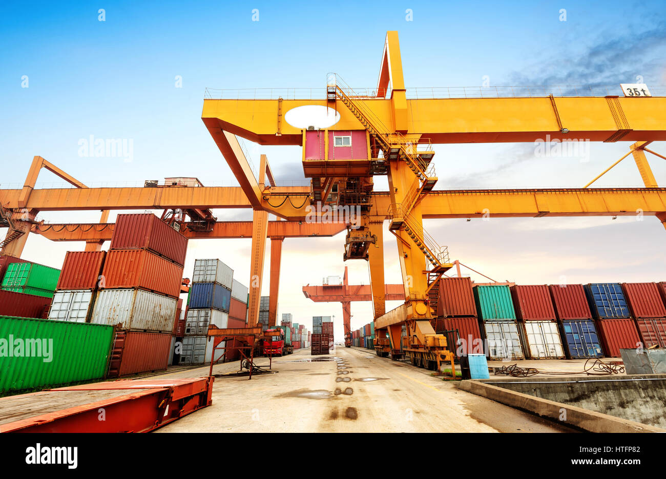 When the container terminal at dusk, work cranes and forklift Stock ...