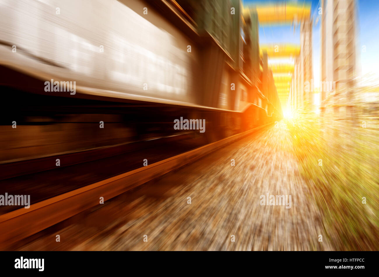 Train passing by in orange sunset Stock Photo - Alamy
