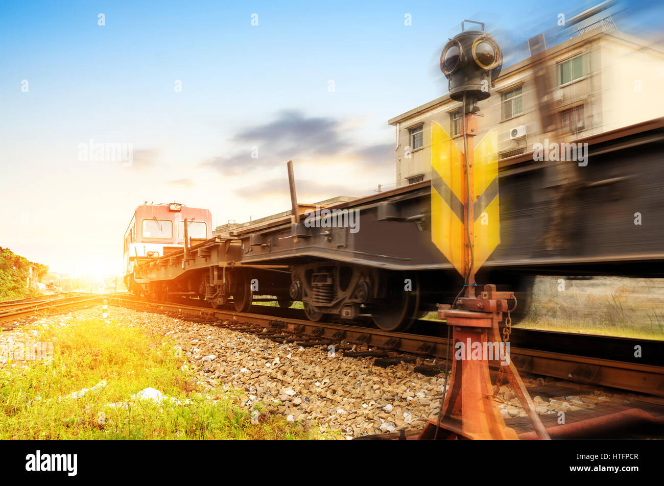 Train passing by in orange sunset Stock Photo - Alamy
