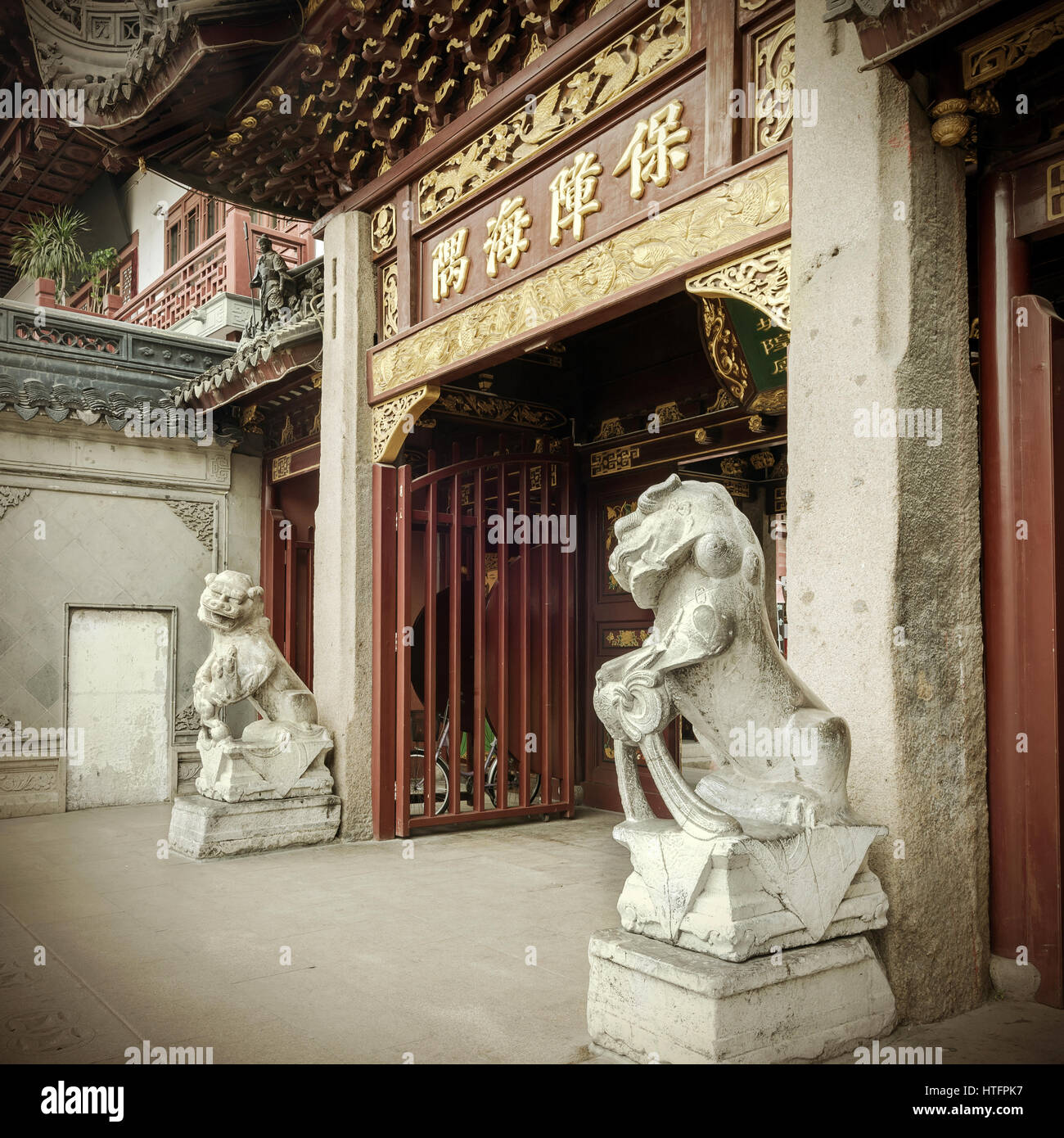 Stone lion guardian statue at the entrance of Shanghai City God Temple ...