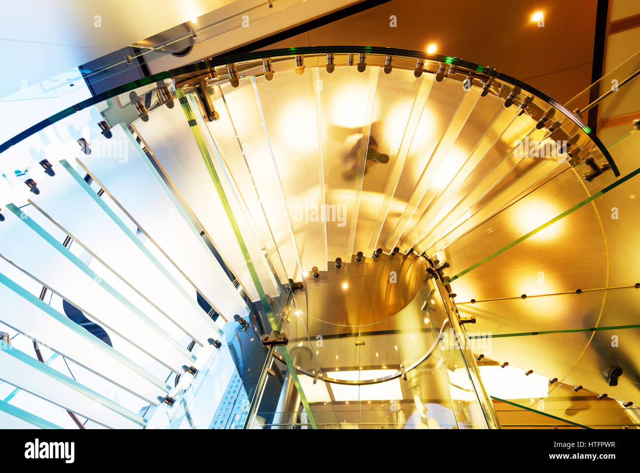 modern glass spiral staircase in shop with motion step Stock Photo - Alamy