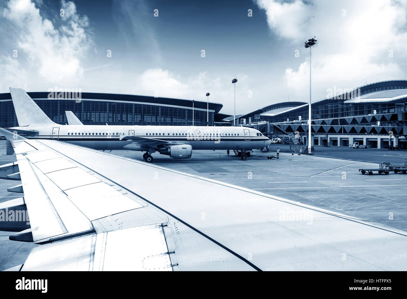 A passenger plane being serviced by ground services before next takeoff ...
