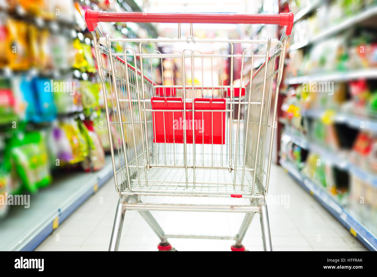 Supermarket interior, empty red shopping cart Stock Photo - Alamy