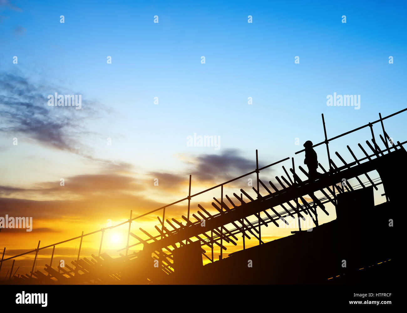 construction workers in the sunset Stock Photo - Alamy
