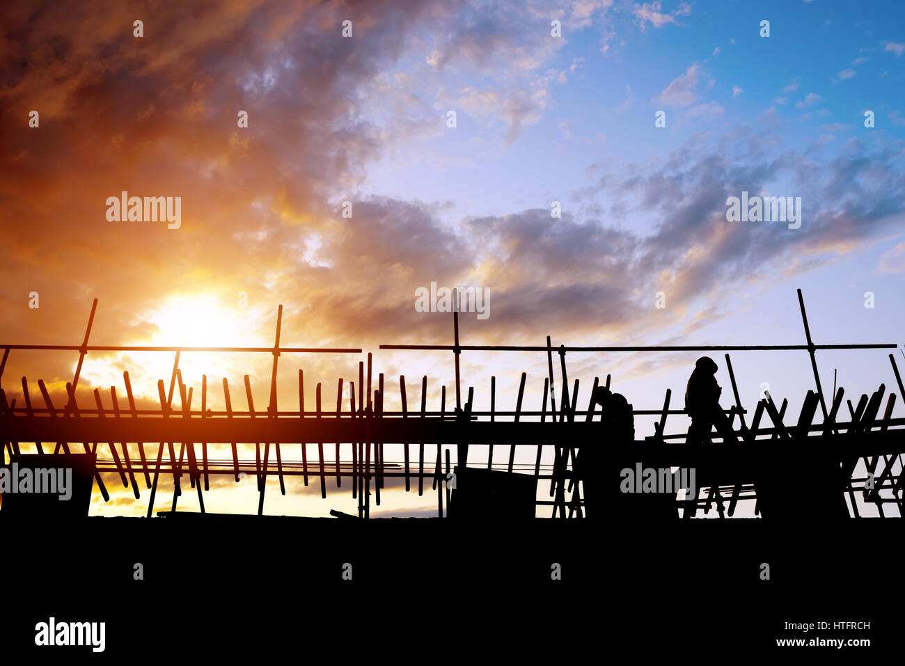 construction workers in the sunset Stock Photo - Alamy